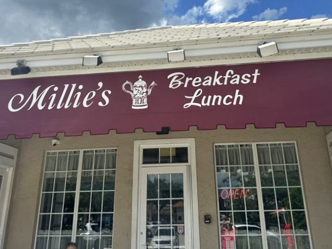 Millie's welcomes you with its charming burgundy awning and cozy bench &ndash; like a breakfast hug before you even walk through the door.