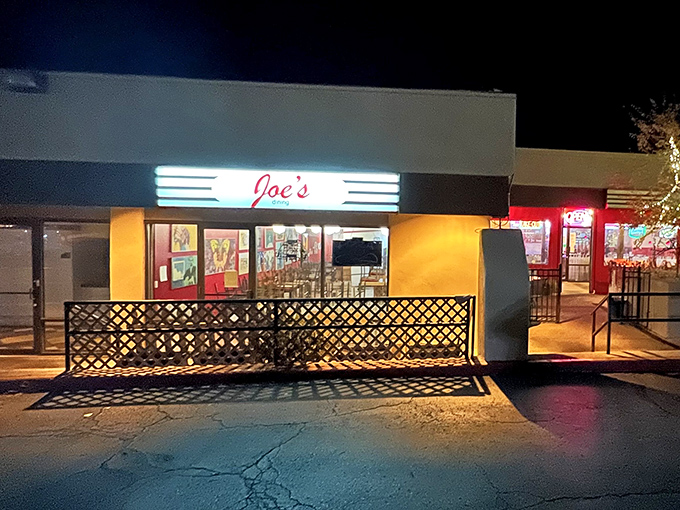 Joe's vibrant red exterior glows like a beacon of culinary promise, standing proudly against the night sky of Santa Fe.