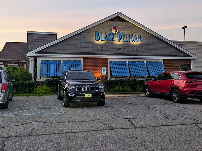 As dusk settles, the illuminated Black Pelican sign becomes a beacon for hungry travelers. The blue shutters practically wink at you, saying "come on in."