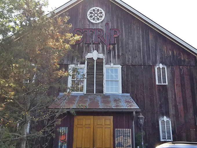 The iconic "STRIP" sign beckons carnivores like a lighthouse for the beef-obsessed. This 19th-century barn has found its true calling as a temple to perfectly cooked steaks.