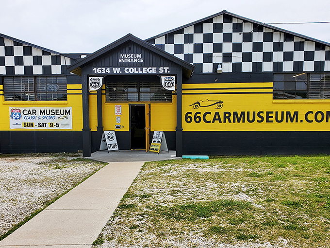 The black-and-yellow checkered facade of the Route 66 Car Museum stands like a racing flag waving you in to explore automotive history in Springfield.