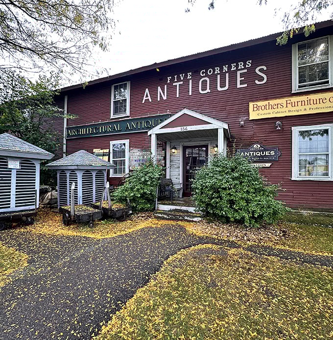 The iconic red exterior of Five Corners Antiques stands like a time portal in Essex Junction, beckoning treasure hunters with promises of discoveries waiting inside.
