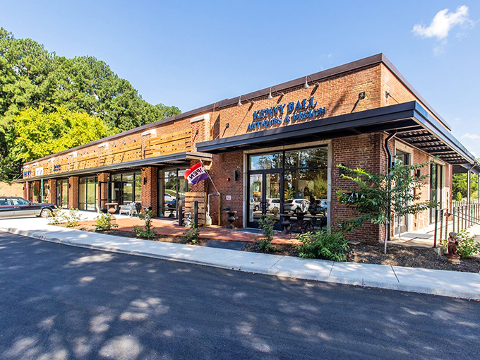 The brick exterior of Kenny Ball Antiques promises treasures within, like a sophisticated version of "The Price is Right" where everything's already a winner.