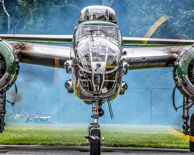 The gleaming nose of Panchito, the B-25 Mitchell bomber, catches sunlight like a mirror to the past. Aviation poetry in polished aluminum.