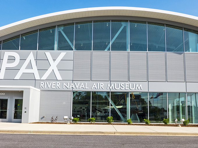 The sleek, modern facade of the Patuxent River Naval Air Museum welcomes aviation enthusiasts with its wing-inspired architecture and promise of aeronautical wonders within.