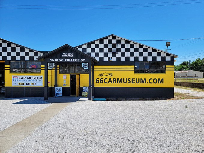 The black-and-yellow checkered facade of the Route 66 Car Museum stands like a racing flag waving you in to explore automotive history in Springfield.