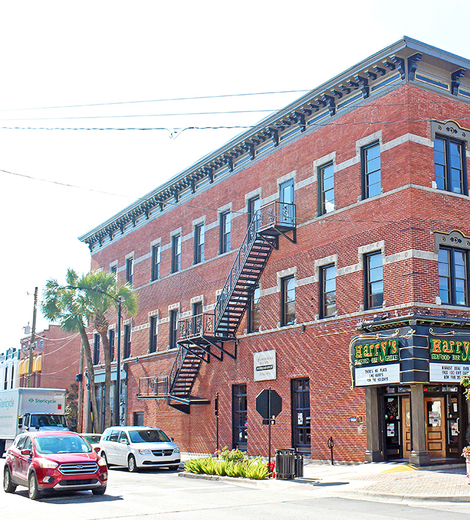 Historic brick buildings like this one in downtown Ocala tell stories of Florida's past while housing today's thriving businesses. Harry's Seafood Bar & Grille beckons from the corner.