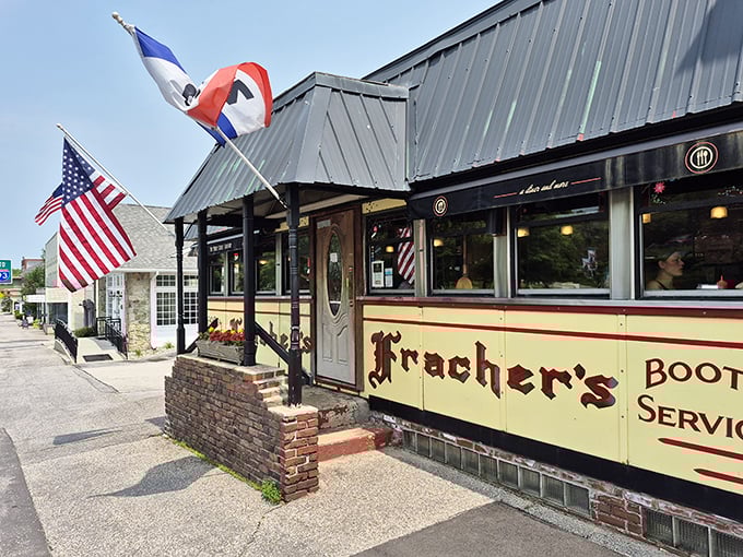 The classic yellow exterior with "Fracher's" signage and American flags announces you've arrived somewhere with history, not just breakfast.