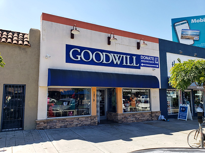 The iconic blue and white storefront of Goodwill on University Avenue stands like a beacon of bargain possibilities in San Diego's Hillcrest neighborhood.