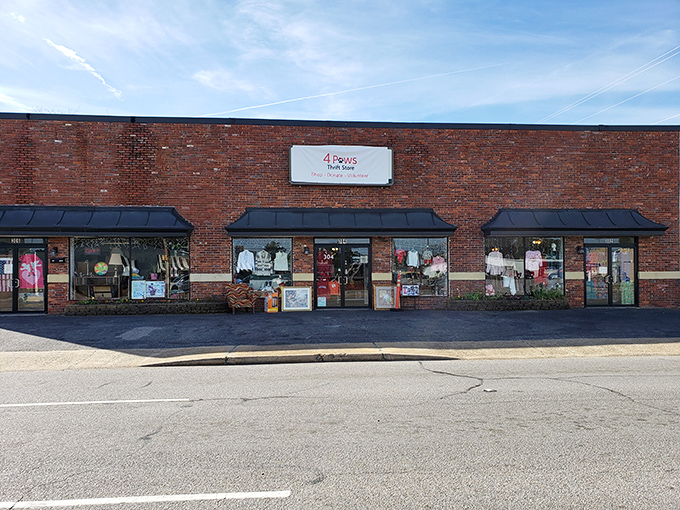 The unassuming brick facade of 4 Paws Thrift Store hides a treasure trove within, like finding the secret entrance to Narnia in a suburban strip mall.