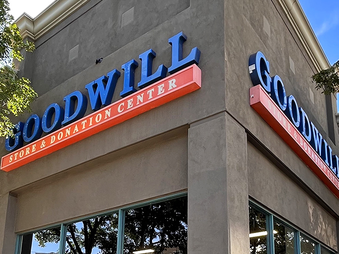 The iconic blue and orange Goodwill signage stands out like a beacon for bargain hunters, promising treasures within those unassuming walls.