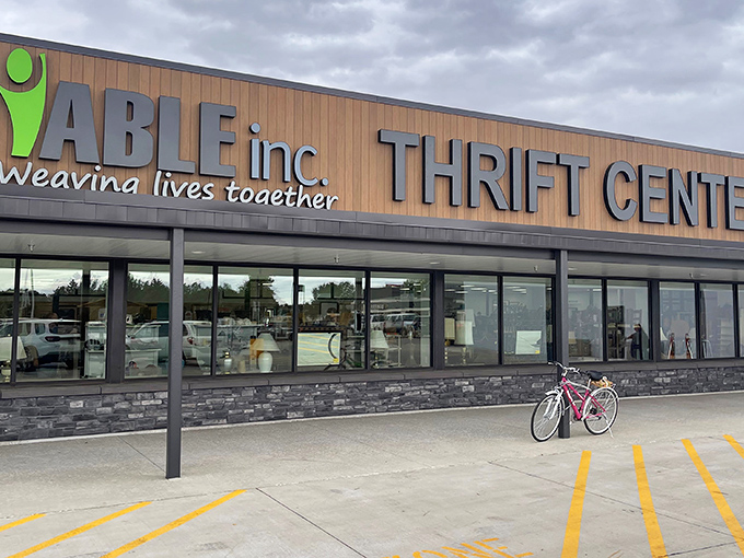 The modern facade of ABLE Thrift Center promises treasures within, its "Weaving lives together" tagline hinting at the community connections made through secondhand shopping.