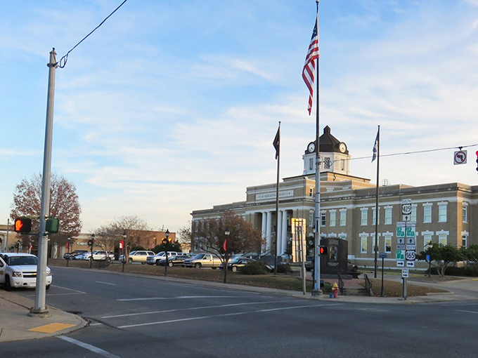 The Morehouse Parish Courthouse stands proudly against the Louisiana sky, a testament to when public buildings were architectural statements, not just functional boxes.