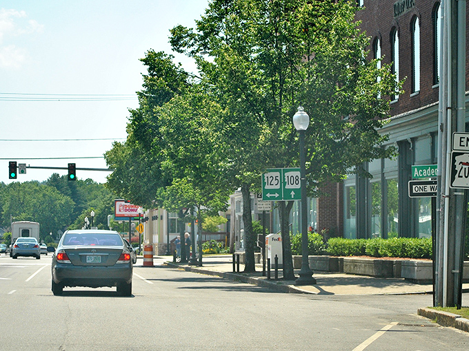 Tree-lined streets and Route 125 signs prove that sometimes the best adventures start with a simple turn off the highway.