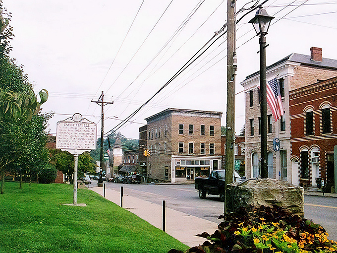 Historic charm meets small-town serenity on Fayetteville's main street, where brick buildings and American flags tell stories that predate your grandmother's recipe book.