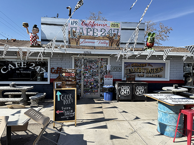 Desert oasis meets roadside charm at Cafe 247, where checkered flags and quirky decor welcome weary travelers seeking refuge from hunger and highway monotony.