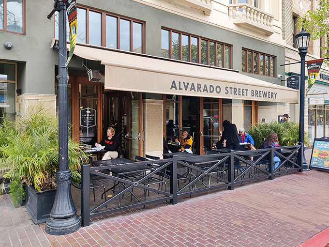 The welcoming storefront of Alvarado Street Brewery beckons passersby with its inviting patio seating and classic Monterey charm. A perfect spot for people-watching while sipping craft beer.