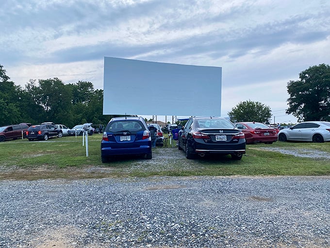 Cars line up facing the blank canvas of possibility&mdash;Bengies' massive screen awaits the magic of twilight showtime.