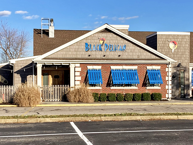 The coastal charm hits you before you even walk in. Those distinctive blue shutters against brick and shingle siding promise seafood done right.