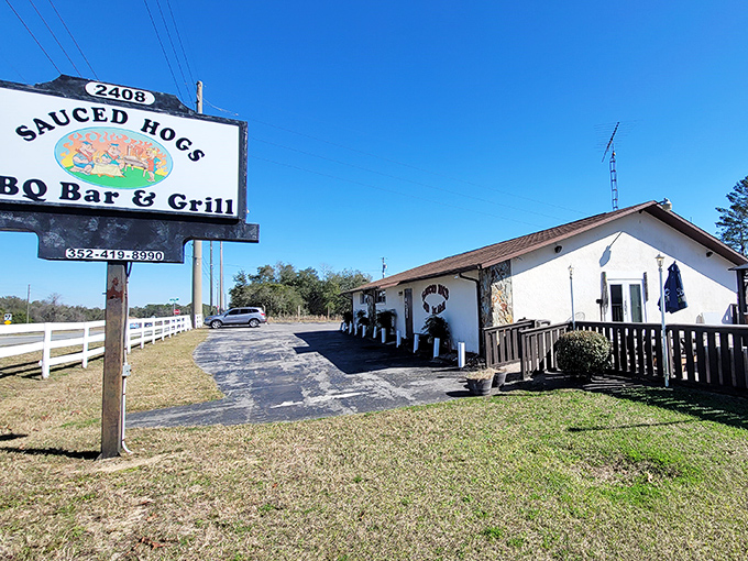 The unassuming white building with its simple sign promises what fancy establishments often can't deliver: authentic, no-nonsense barbecue worth the drive.