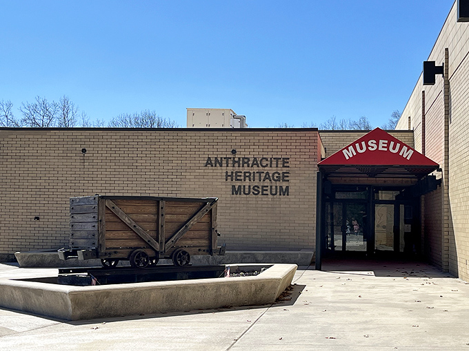A vintage coal cart greets visitors outside, like a time-traveling ambassador saying "You're about to take a journey into Pennsylvania's gritty past."