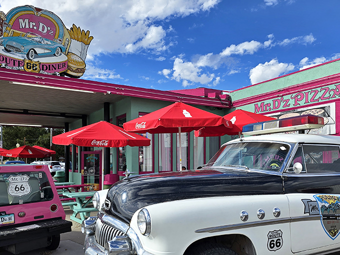 The teal and pink facade of Mr. D'z pops against the Arizona sky like a Technicolor dream, complete with vintage cars that make you question which decade you're in.