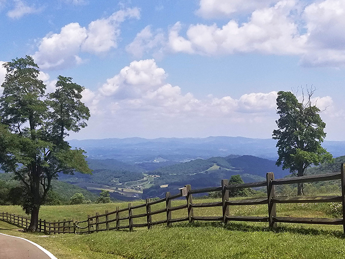 This picturesque view is absolutely breathtaking! Love the rolling green hills and endless mountains under a sunny sky.