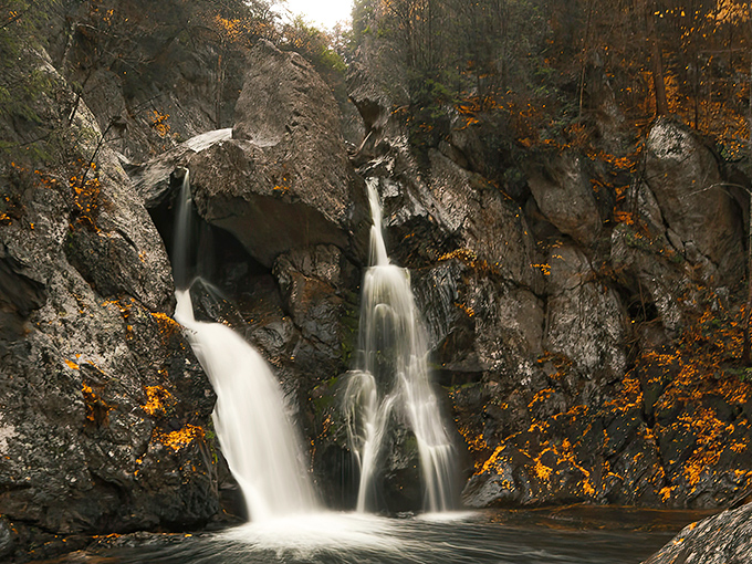 Nature's masterpiece in motion: Bash Bish Falls splits dramatically around ancient rock, creating twin cascades that seem choreographed by some artistic force of the wilderness.