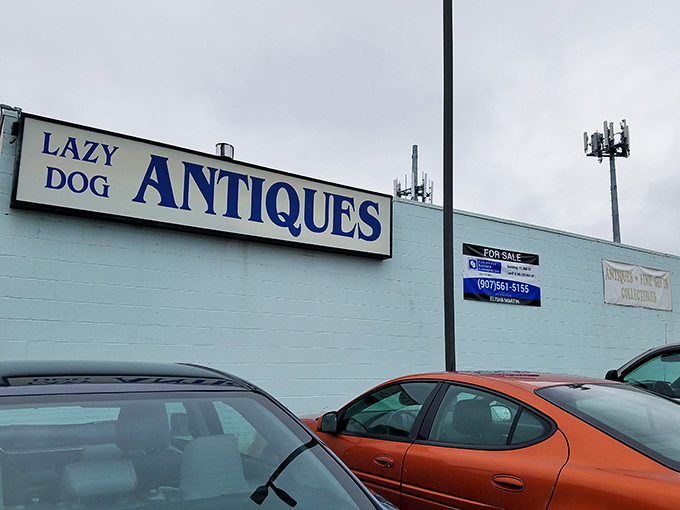 The iconic blue sign beckons treasure hunters from across Alaska, promising adventures in time travel disguised as shopping.