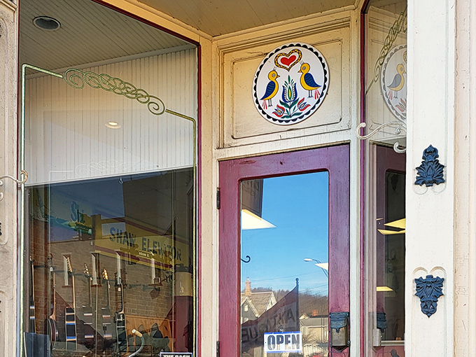 The charming storefront of Village Antique Emporium beckons with treasures waiting to be discovered behind that distinctive purple door.