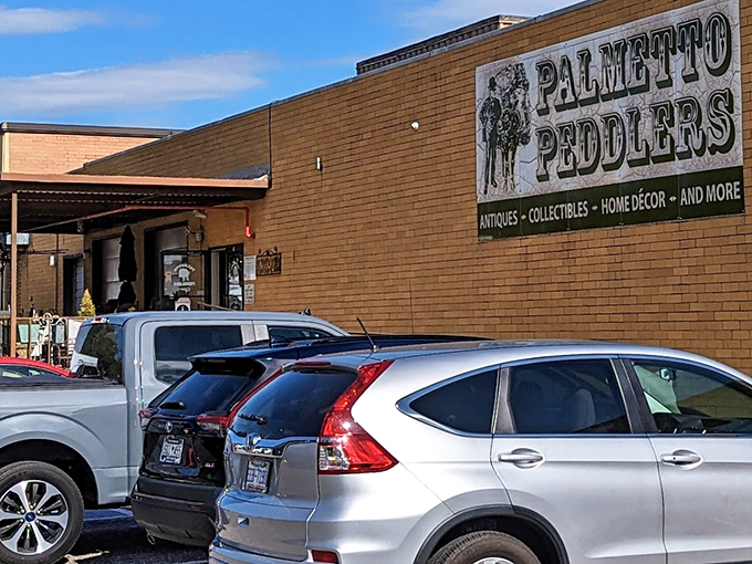 The unassuming exterior of Palmetto Peddlers hides a universe of treasures within, like a time-travel portal disguised as a brick building.
