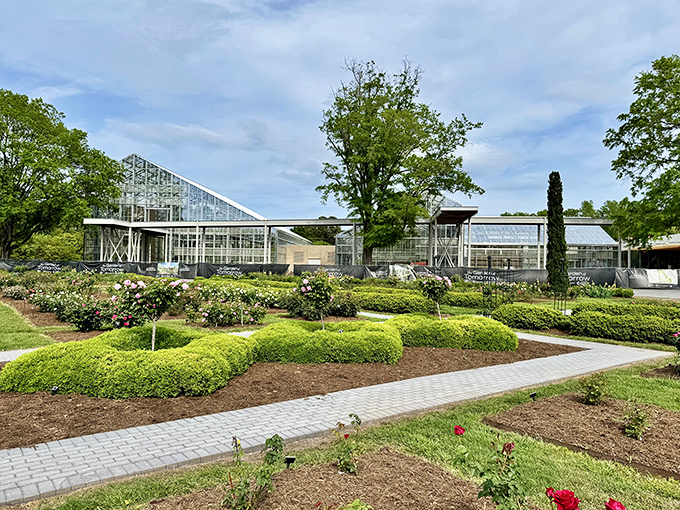 Modern meets botanical in this sleek visitor center. The glass structure invites sunlight to dance among the meticulously manicured hedges.