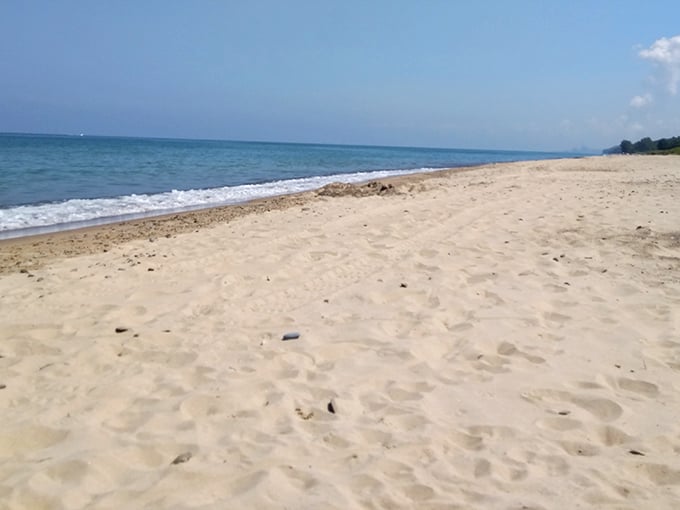 Soft sand stretches to meet crystal waters, creating that rare moment when Indiana feels like a coastal paradise.