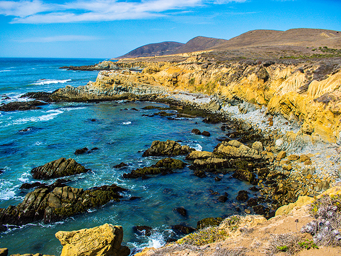 Golden cliffs meet turquoise waters in a geological masterpiece that would make even the most jaded traveler pause in wonder.