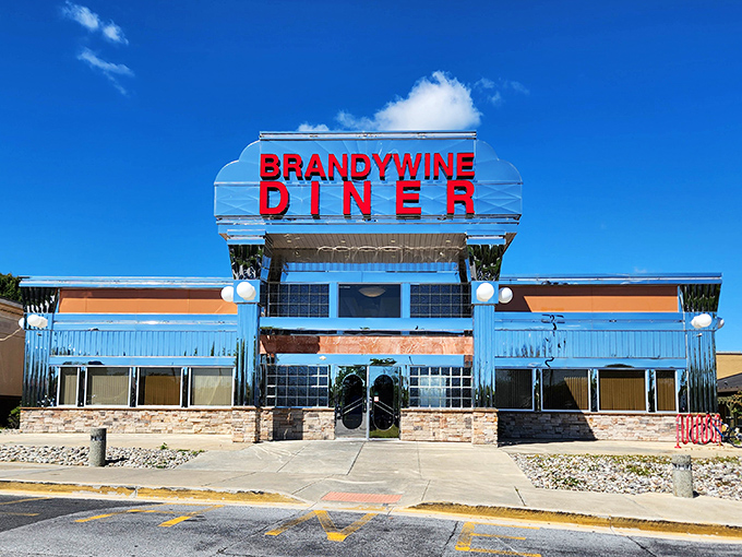 The iconic Brandywine Diner exterior gleams against a perfect blue Delaware sky, beckoning hungry travelers with its retro charm and promise of comfort food paradise.