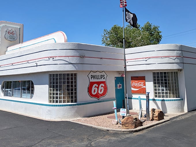 The gleaming white exterior of 66 Diner stands as a Route 66 time capsule, its curved lines and vintage signage beckoning hungry travelers.