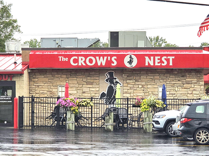 The bold red signage against stone walls announces you've arrived somewhere special. Even in the rain, The Crow's Nest beckons with its dapper crow mascot.
