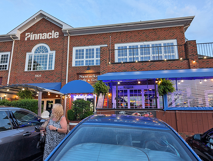 Nantucket Grill's brick fa&ccedil;ade and bright blue awnings welcome diners like a coastal lighthouse beckoning hungry sailors home. The outdoor patio promises al fresco delights under Carolina skies.