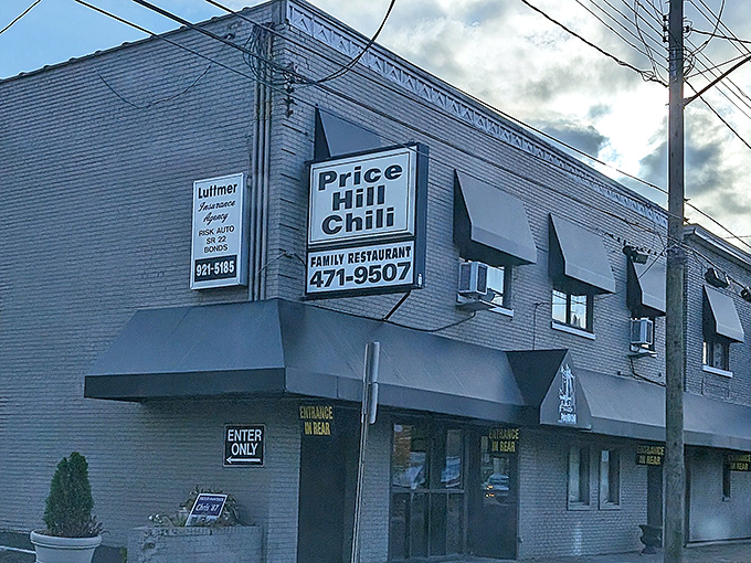 The unassuming brick exterior of Price Hill Chili stands like a culinary lighthouse, beckoning hungry Cincinnatians with its iconic blue awnings and no-nonsense signage.