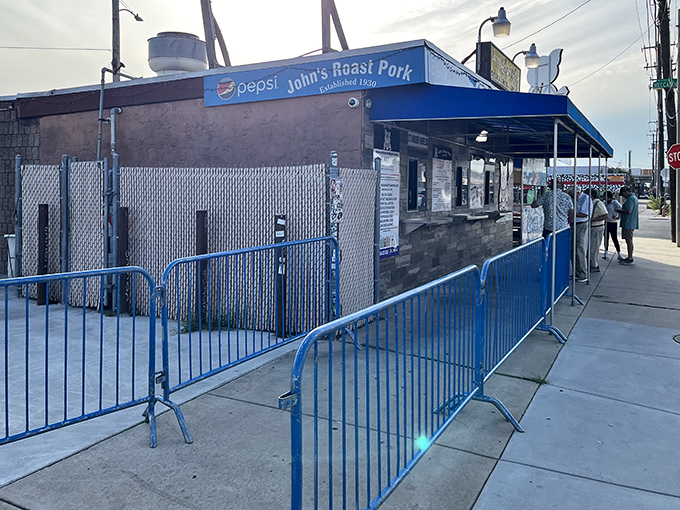 The blue-awninged fortress of flavor stands proudly in South Philly, where sandwich pilgrims line up daily for a taste of perfection.