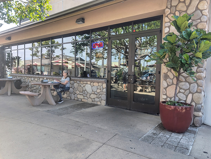 The unassuming stone exterior hides seafood treasures within, like finding Neptune's palace disguised as a beachside bungalow.