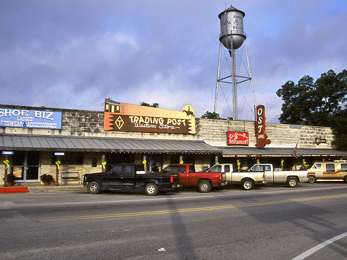 The iconic water tower stands sentinel over Bandera's Trading Post, where pickup trucks outnumber sedans and cowboy hats aren't just fashion statements.