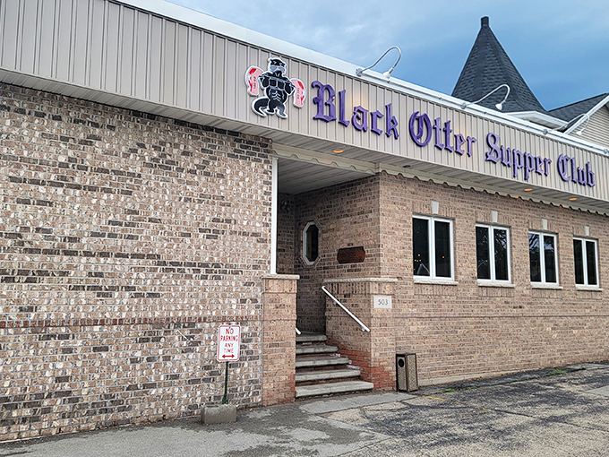 The Black Otter Supper Club stands proudly in daylight, its brick exterior promising Midwest comfort and legendary prime rib within.