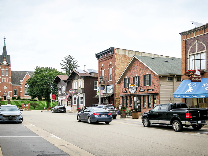 Main Street New Glarus, where Swiss heritage meets Midwest hospitality. The church watches over a downtown that hasn't surrendered to chain stores or hurried living.