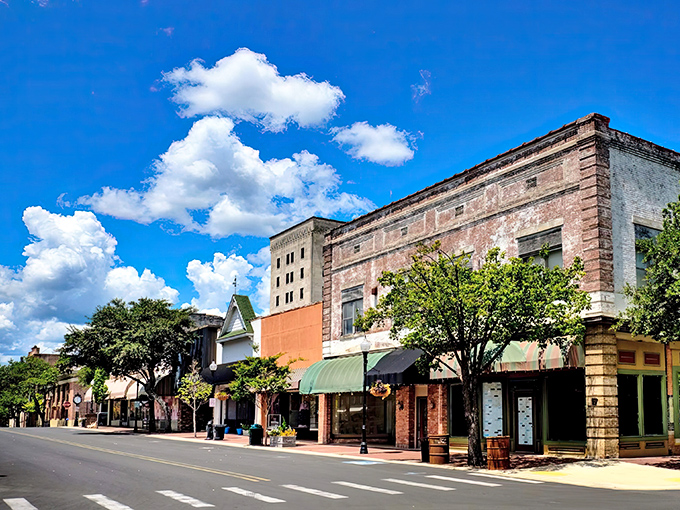 Blue skies frame El Dorado's meticulously preserved Main Street, where century-old architecture houses thriving local businesses instead of the usual chain store suspects.