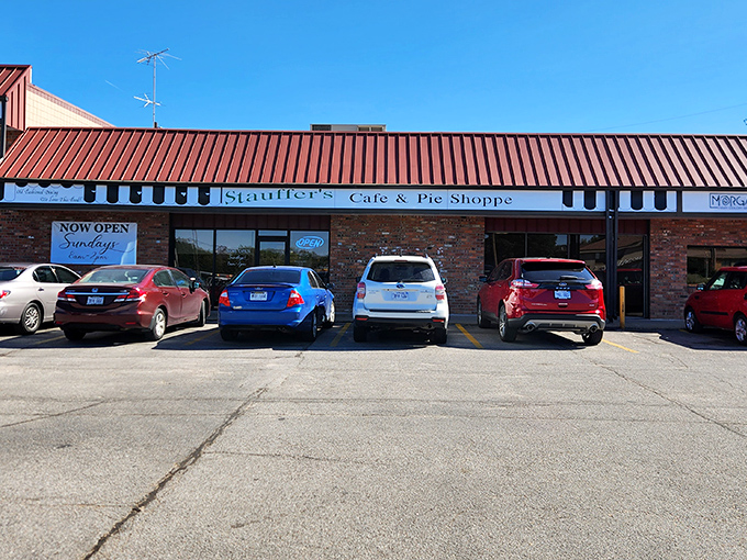 The red-striped awning beckons like a lighthouse for hungry souls. Stauffer's brick exterior promises comfort food treasures within.