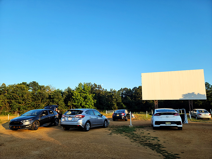 Cars lined up facing the massive white screen at dusk, where memories are made under New Jersey skies. The perfect summer night awaits.