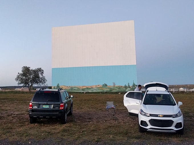 The golden hour glow bathes the massive screen as moviegoers settle in for the evening's entertainment. Some traditions just get better with time.