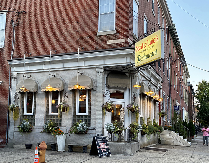 The iconic yellow sign and charming white-painted brick exterior of Dante & Luigi's stands as Philadelphia's culinary lighthouse, guiding hungry souls to Italian bliss for generations.
