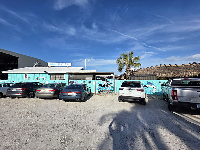 The turquoise facade of The Big Catch welcomes seafood lovers with Florida charm and the promise of waterfront dining under those perfect blue skies.